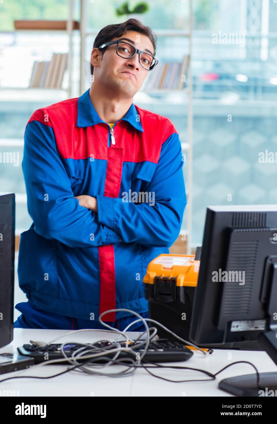 The computer repairman working on repairing computer in it workshop ...