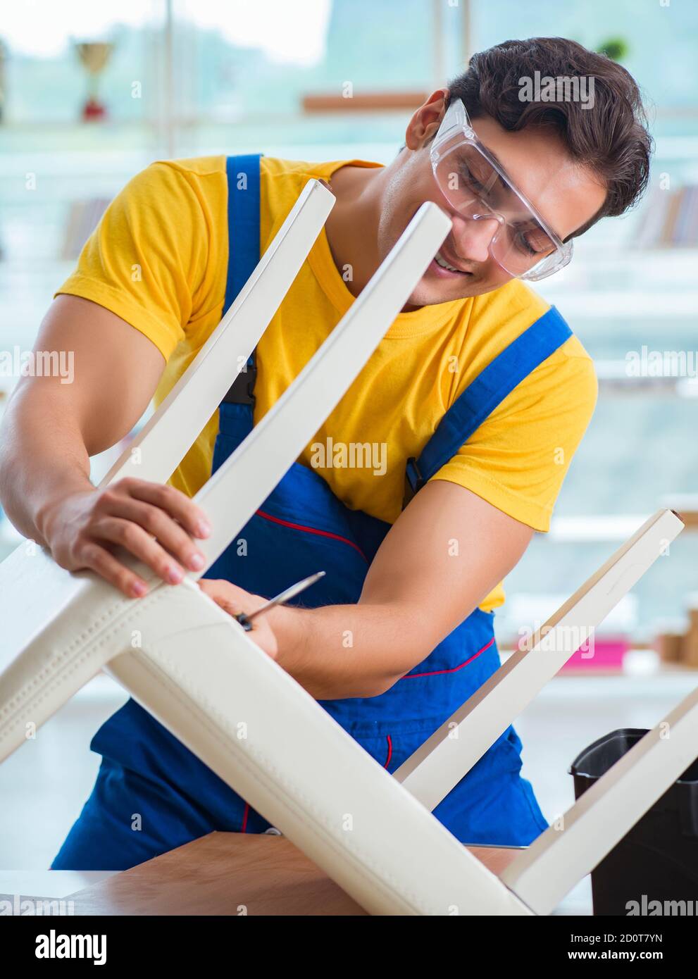 The furniture repairman working on repairing the chair Stock Photo - Alamy