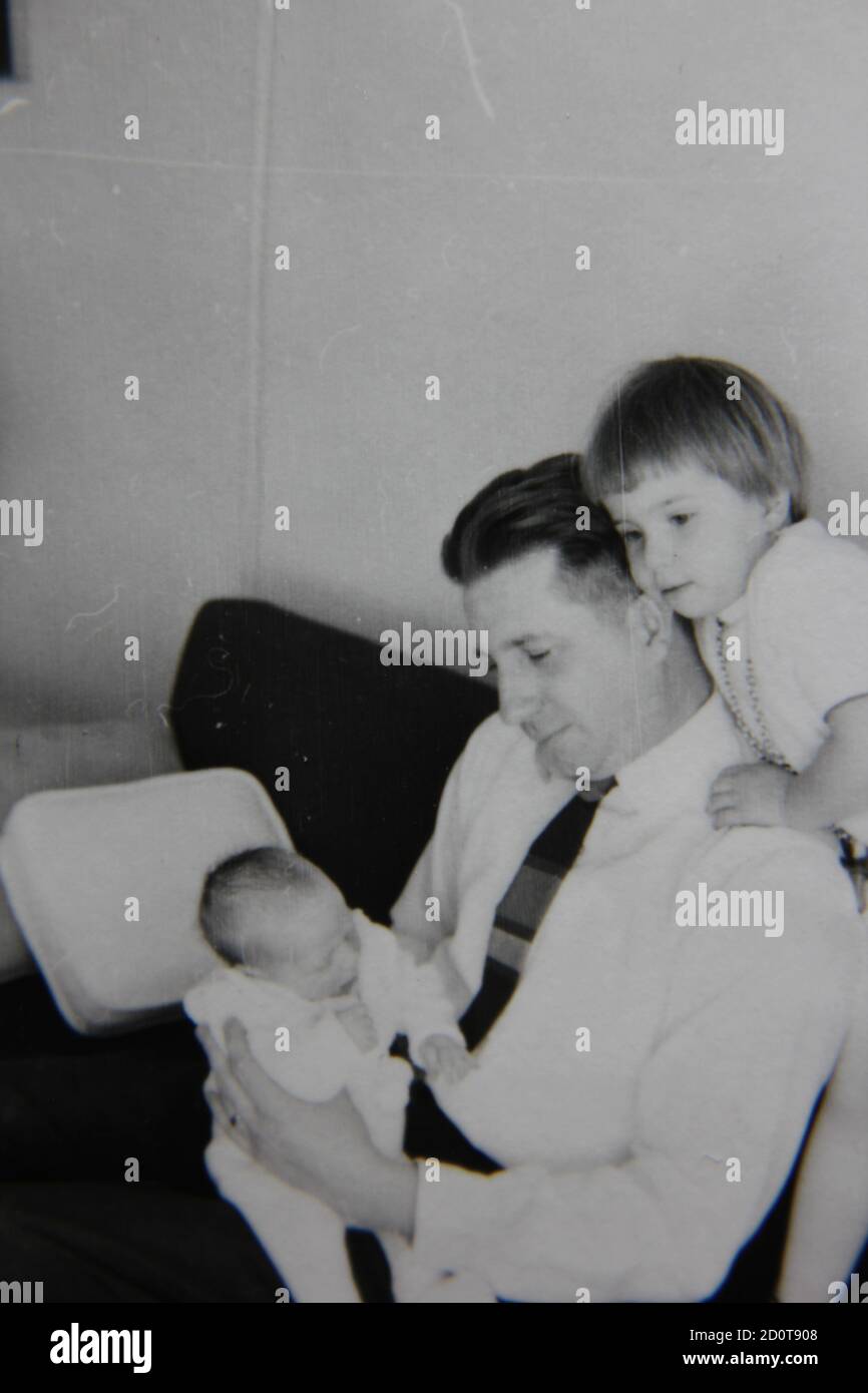 Fine 1970s vintage black and white photography of a new father enjoying ...