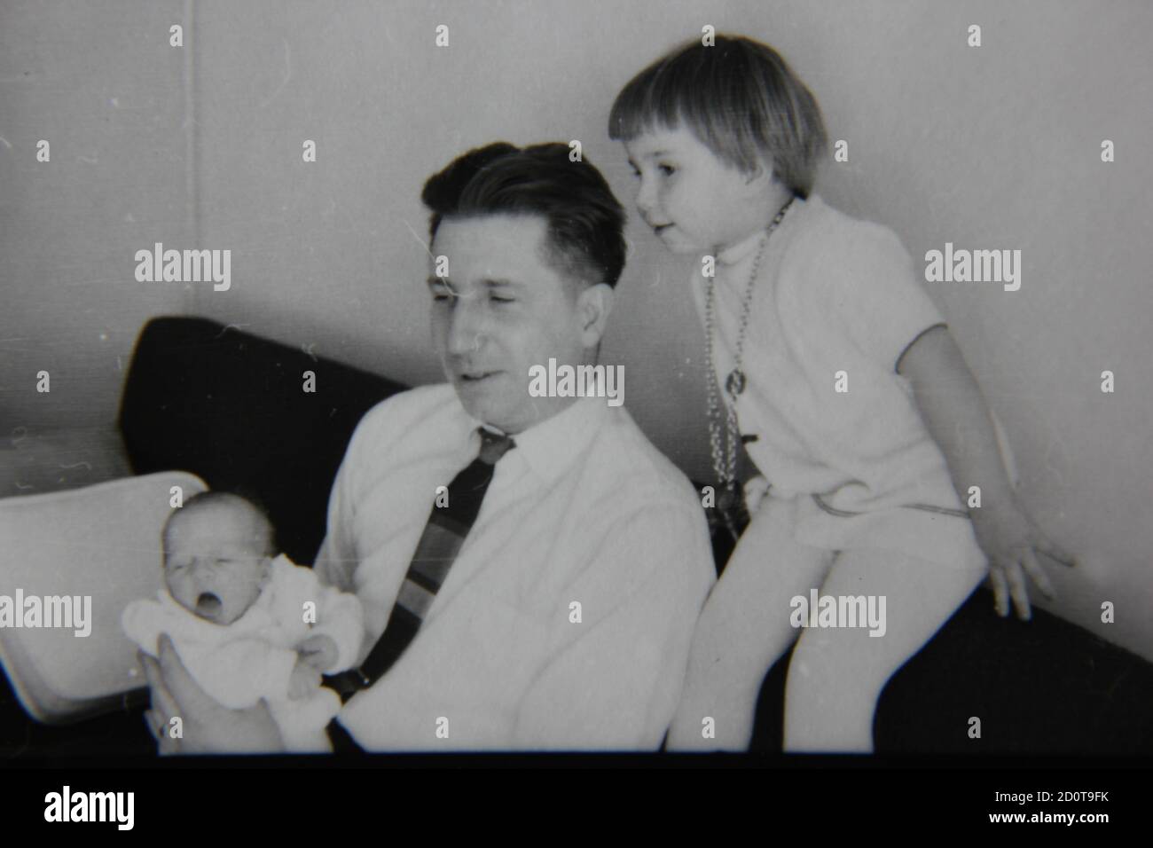 Fine 1970s vintage black and white photography of a new father enjoying ...