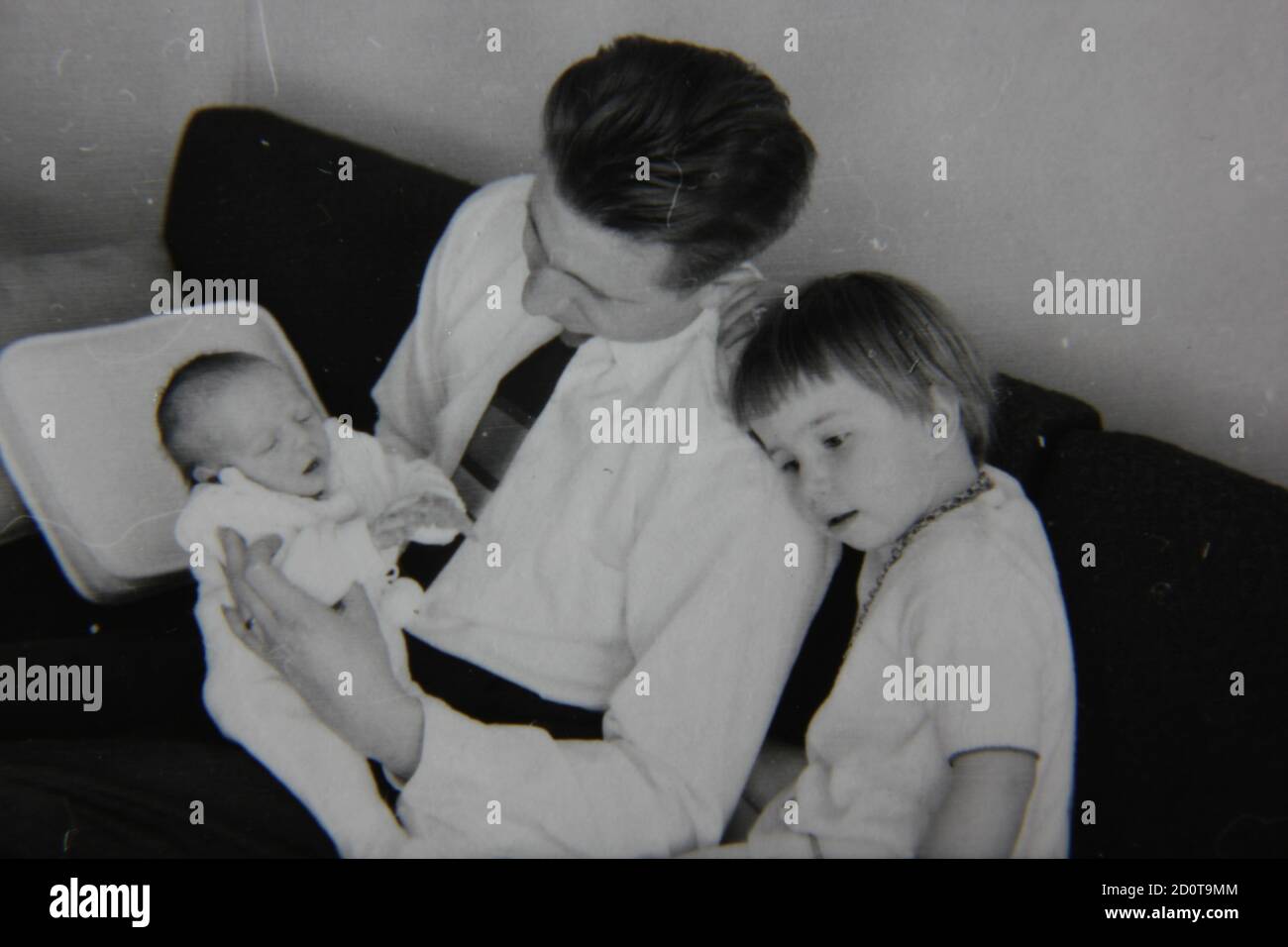 Fine 1970s vintage black and white photography of a new father enjoying ...