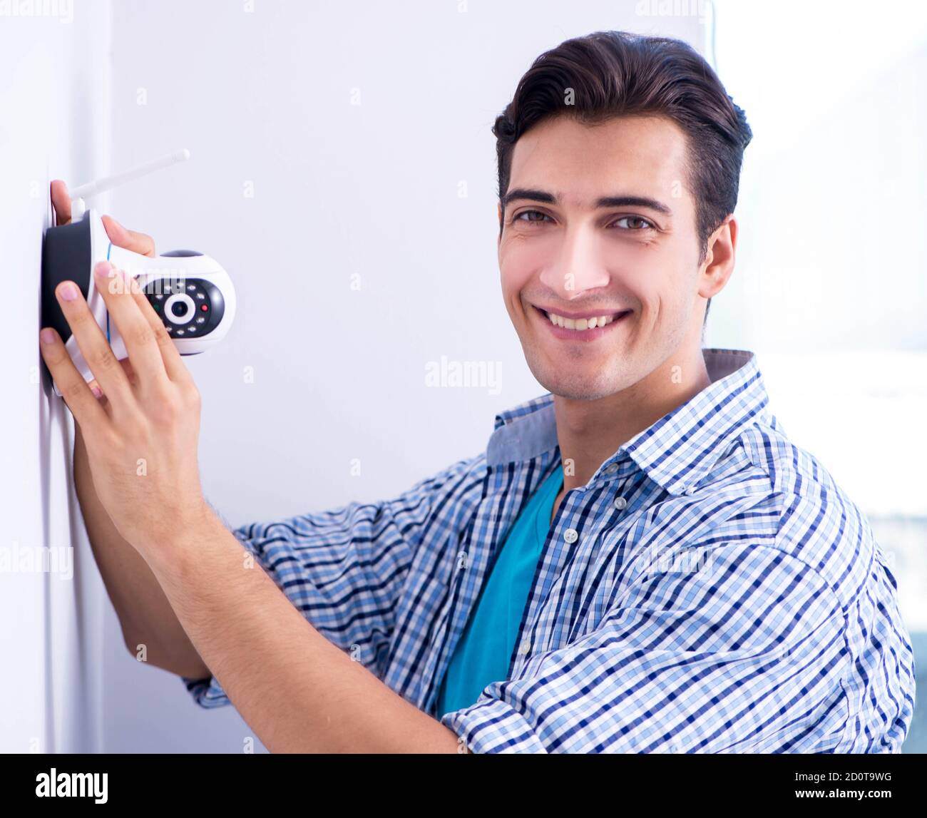 The man installing surveillance cctv cameras at home Stock Photo - Alamy