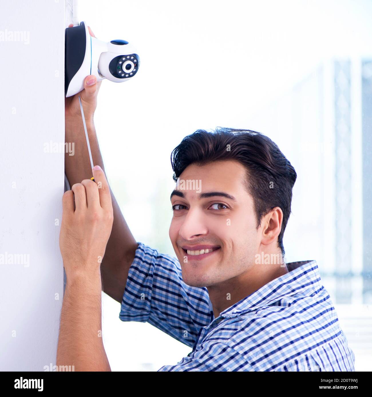 The man installing surveillance cctv cameras at home Stock Photo - Alamy