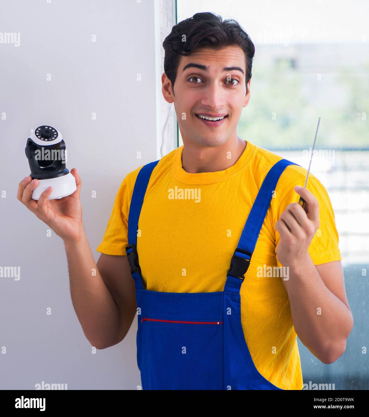 The contractor installing surveillance cctv cameras in office Stock ...