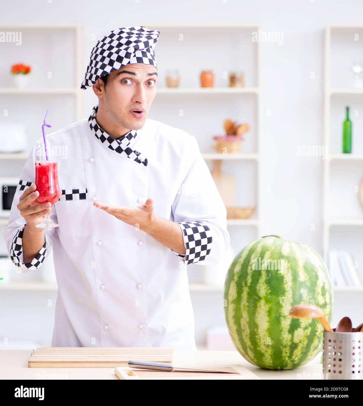 The male cook with watermelon in kitchen Stock Photo - Alamy