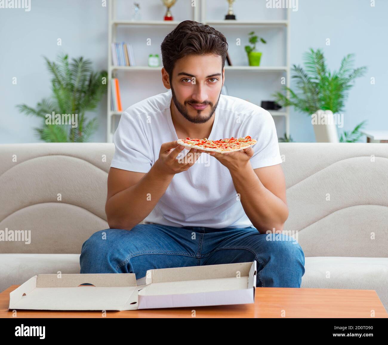 The man eating pizza having a takeaway at home relaxing resting Stock ...