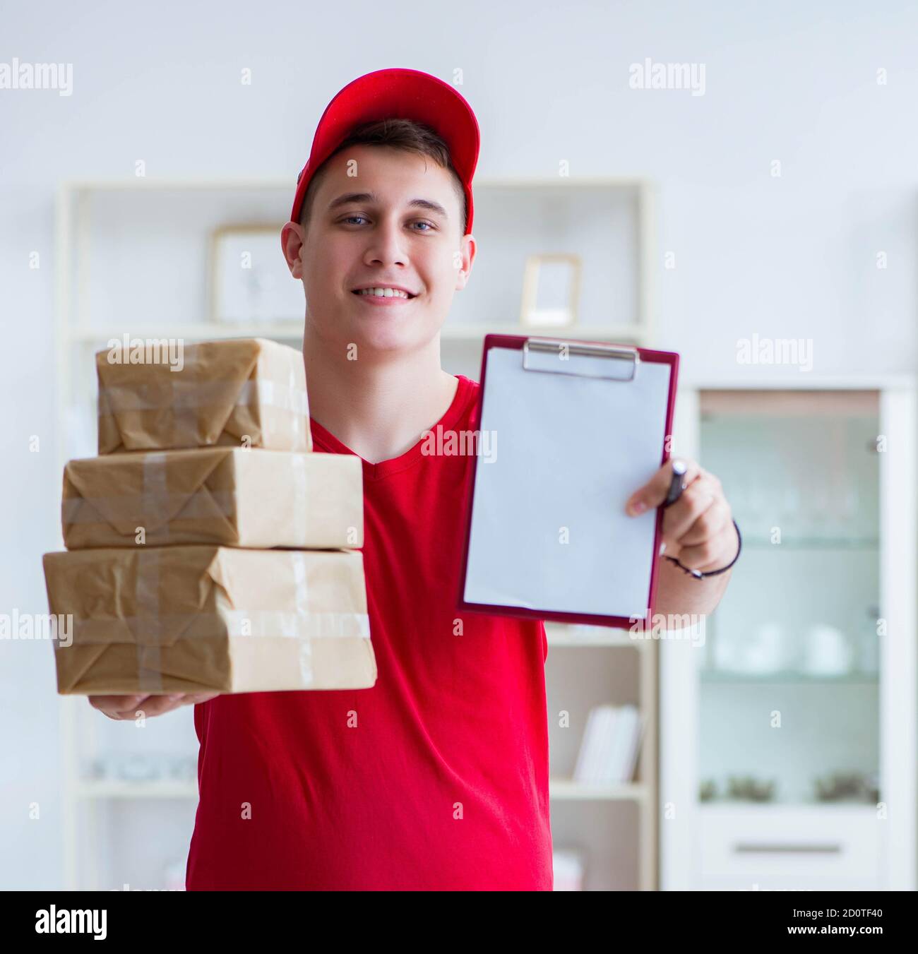 The post man delivering a parcel package Stock Photo - Alamy