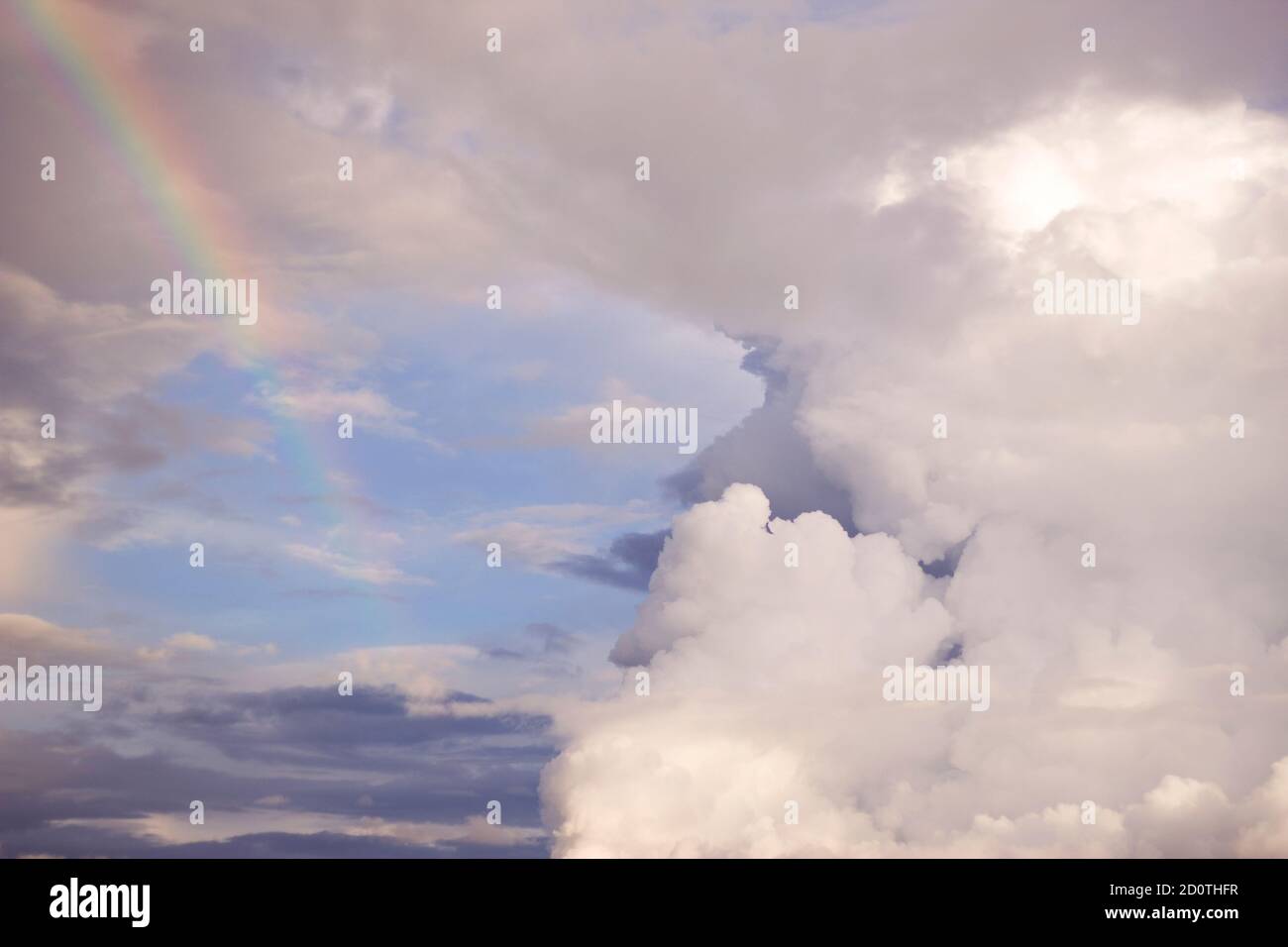 kissing clouds in the evening sky with rainbow after raining a unique ...