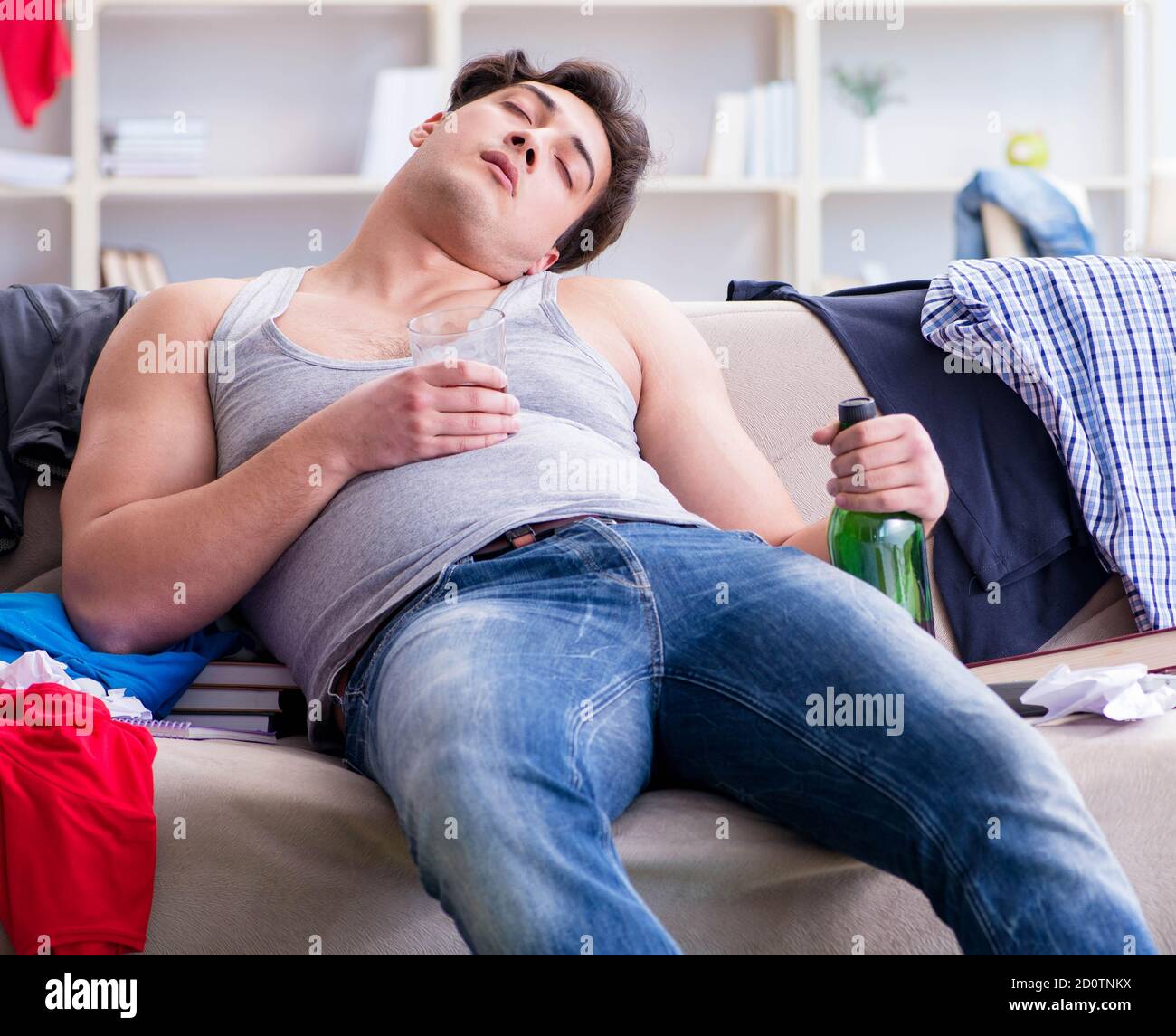 The young man student drunk drinking alcohol in a messy room Stock ...