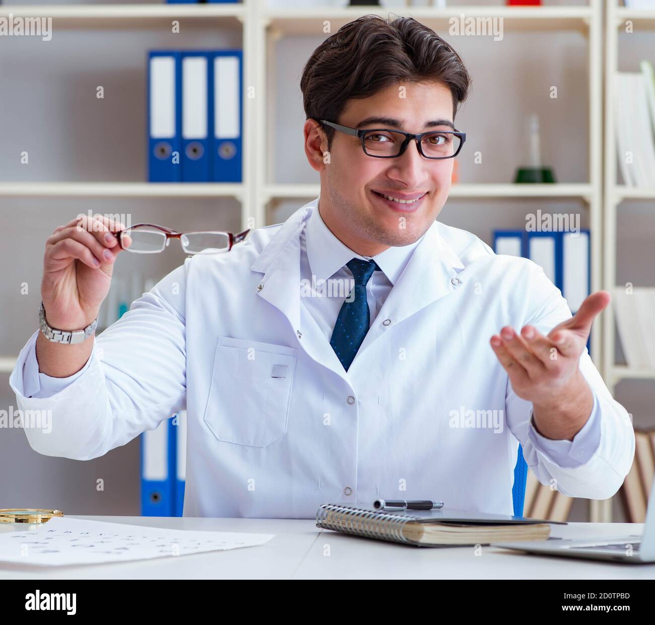 Doctor optician prescribing holding optical glasses Stock Photo - Alamy