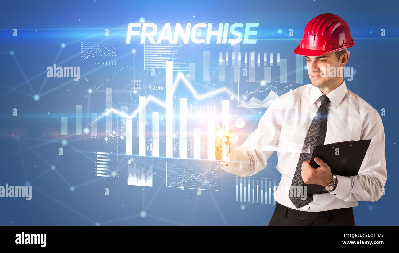 Handsome businessman with helmet drawing FRANCHISE inscription ...