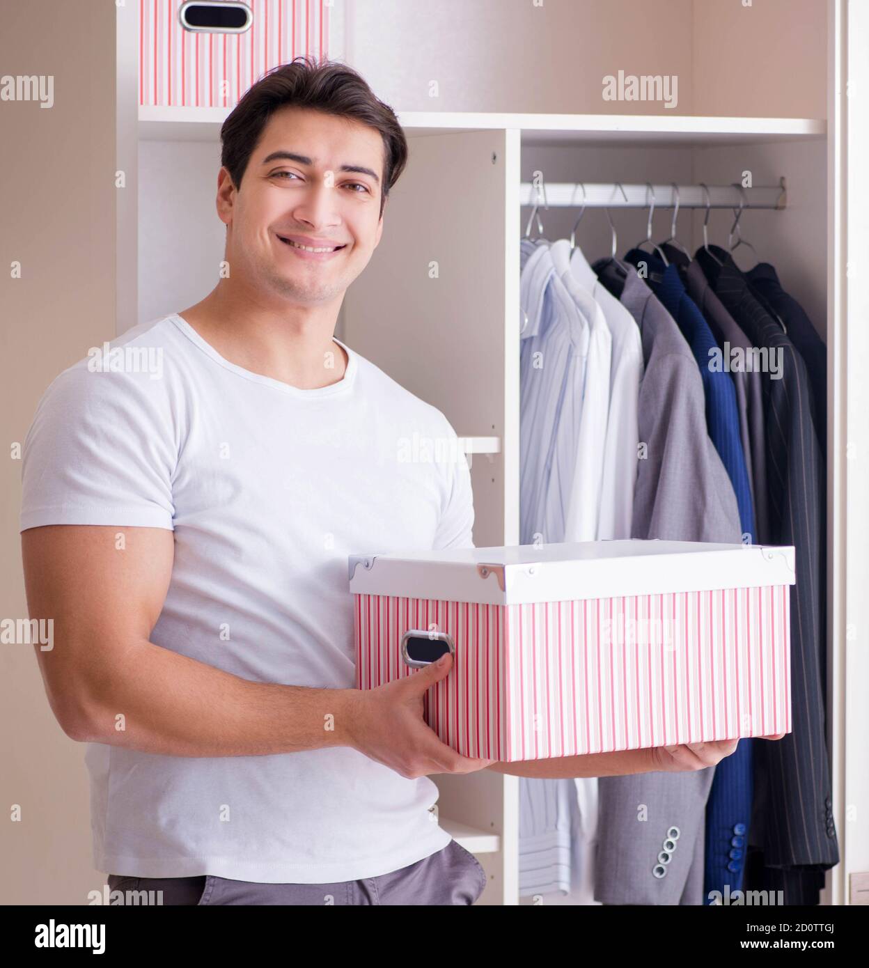 The young man businessman getting dressed for work Stock Photo - Alamy