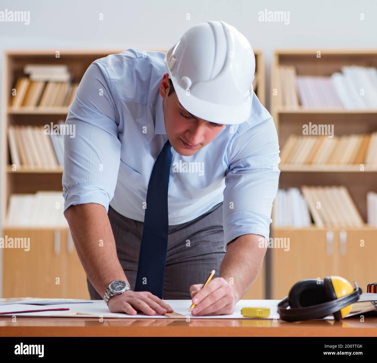 The engineer supervisor working on drawings in the office Stock Photo ...