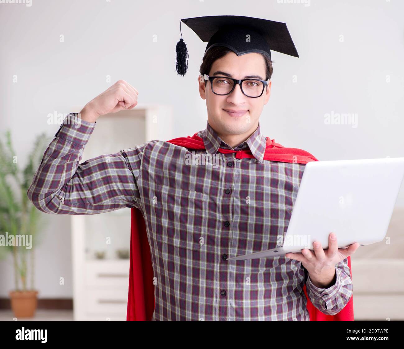 The super hero student wearing mortarboard and holding a laptop Stock ...