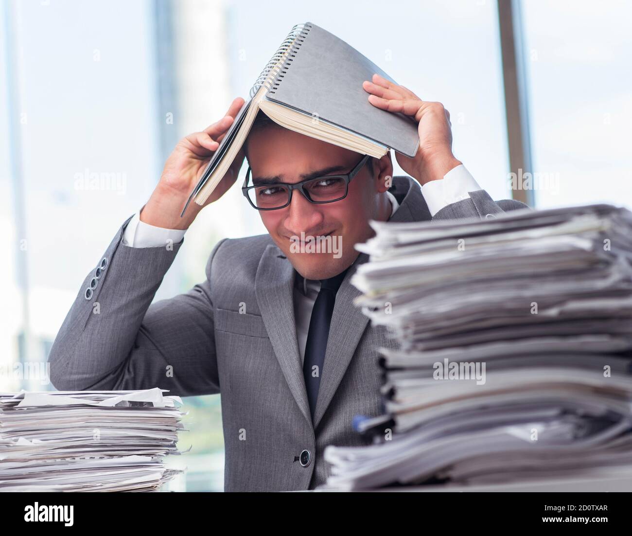 The busy angry businessman with heaps of paper Stock Photo - Alamy