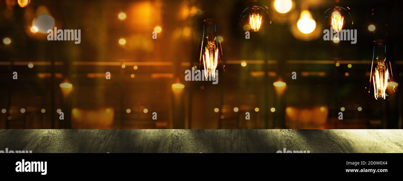 top of wood table with blur bar or pub with vintage lamp in dark night ...