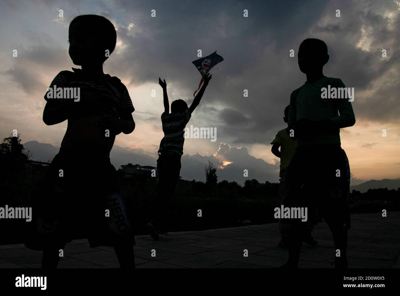 Kathmandu, Nepal. 11th Oct, 2020. A silhouette of a kid flying a kite ...