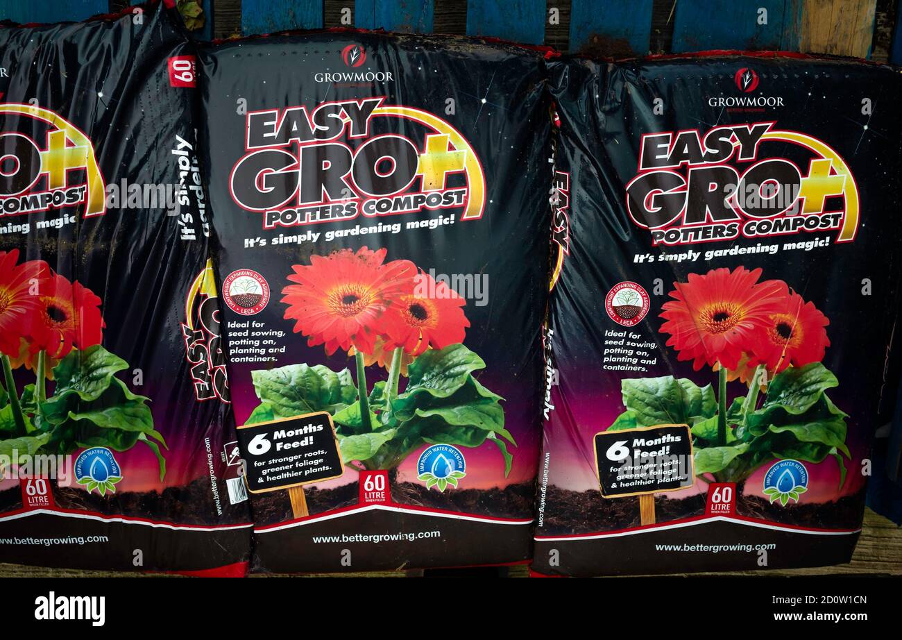 A stack of 60L bags of Growmore Easy Gro Potters Compost for sale in a ...