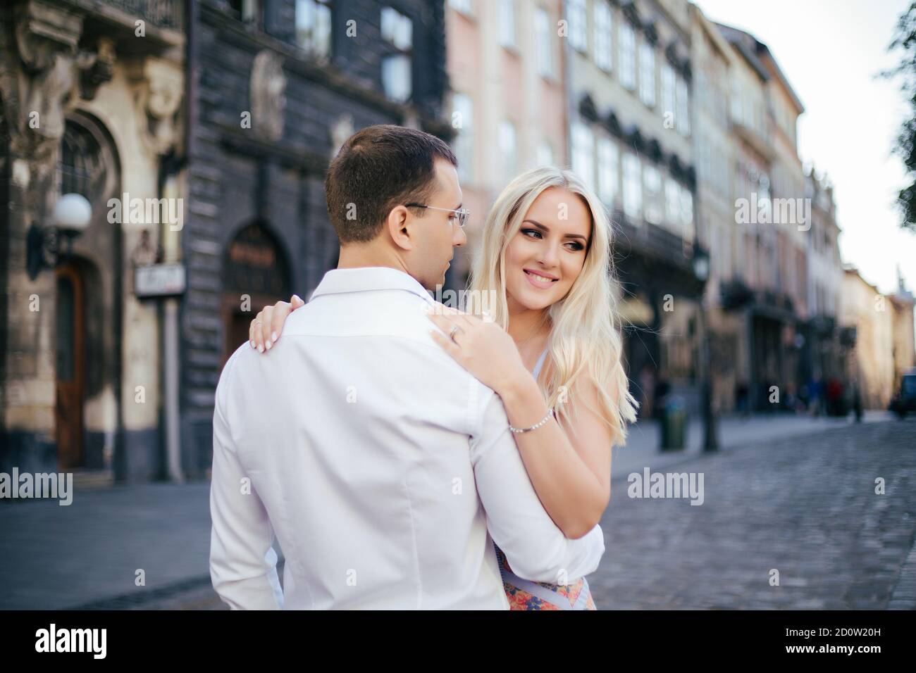 Young couple in love hug each other on city background Stock Photo - Alamy