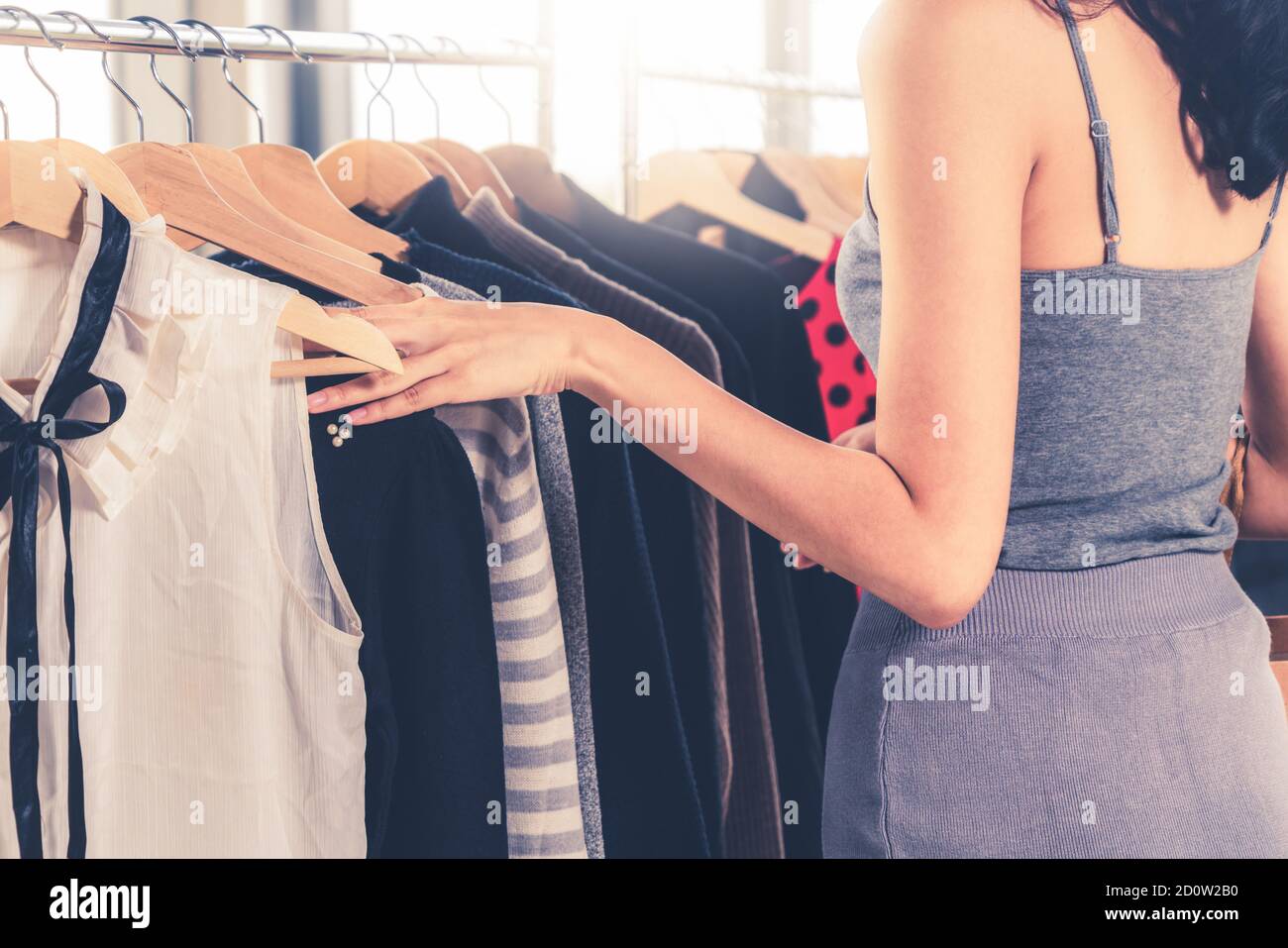 Beautiful woman shopping for clothes at retail apparel shop in the ...
