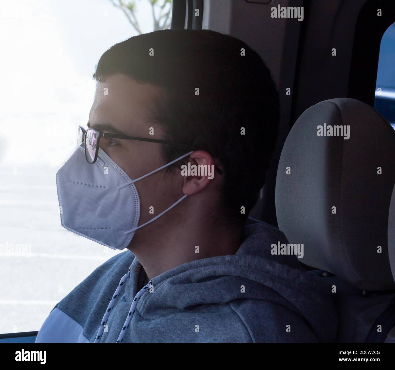 young co-pilot in a vehicle with the covid19 virus protection mask ...