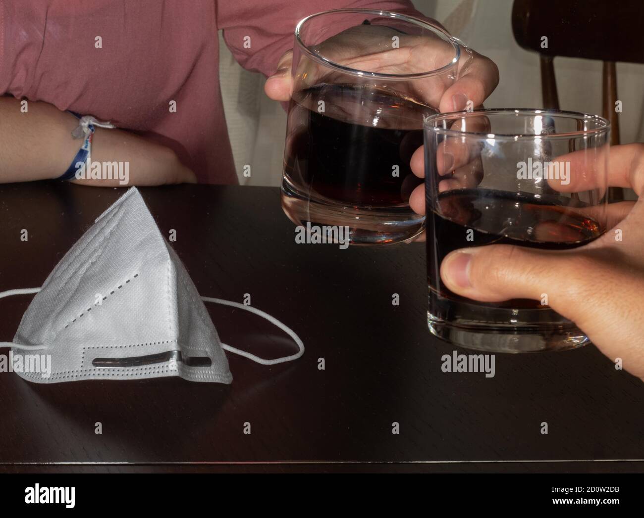 two young people drinking a soft drink during the covid19 with the ...