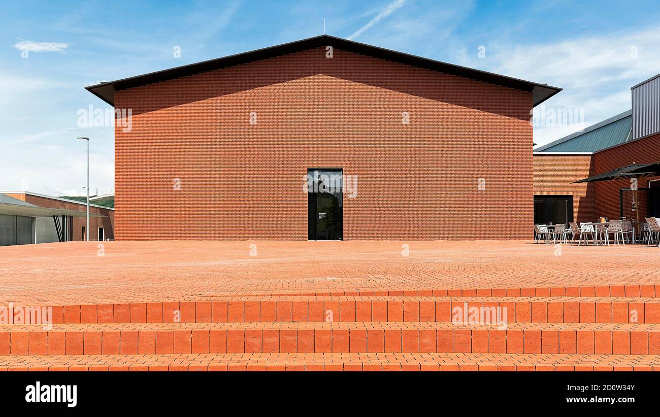 Windowless red brick building in the shape of a warehouse, modern ...