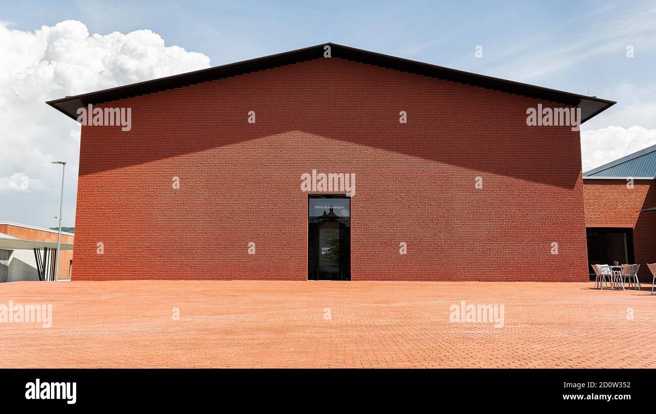 Windowless red brick building in the shape of a warehouse, modern ...