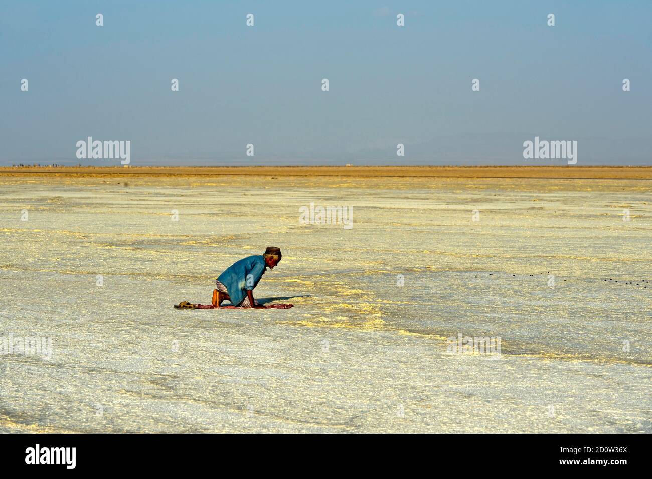 Believer Muslim praying in the desert, Assale salt lake near Hamadela ...
