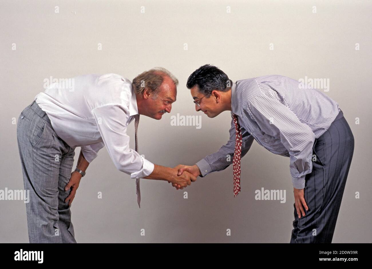 Businessmen shake hands, funny, deep bow, Berlin, Germany, Europe Stock ...