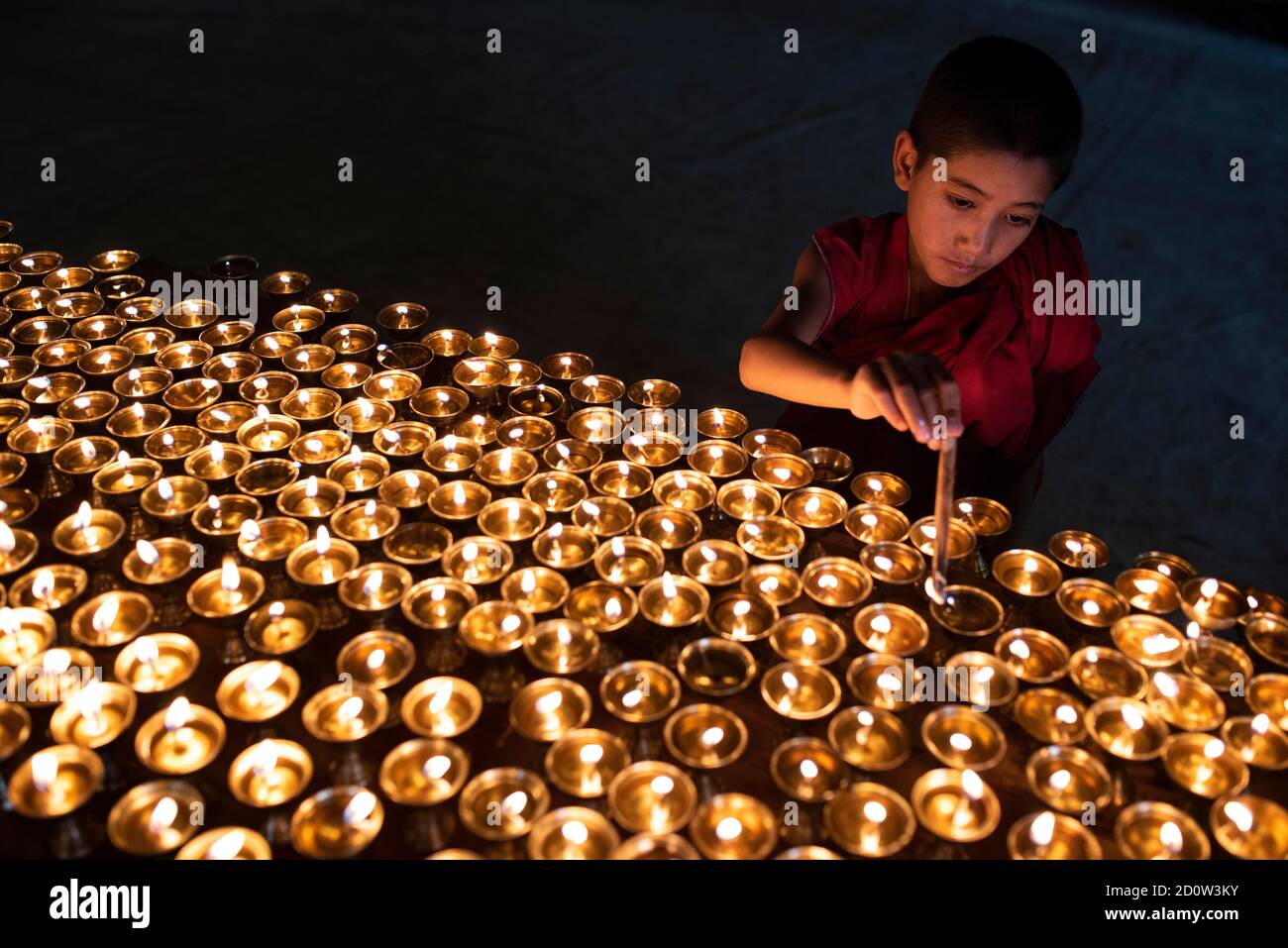 Buddhist children's monk, novice lights butter lamps, Lamayuru ...