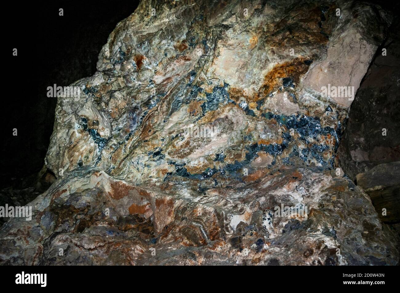 Vein of galena (lead ore) in a complex matrix of other minerals in a ...