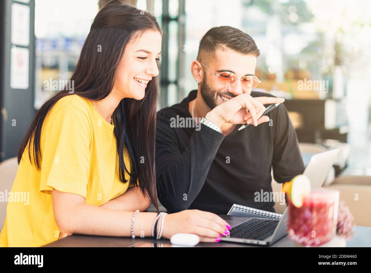 Happy creative team work in a bar with laptop computer in cafe bar ...