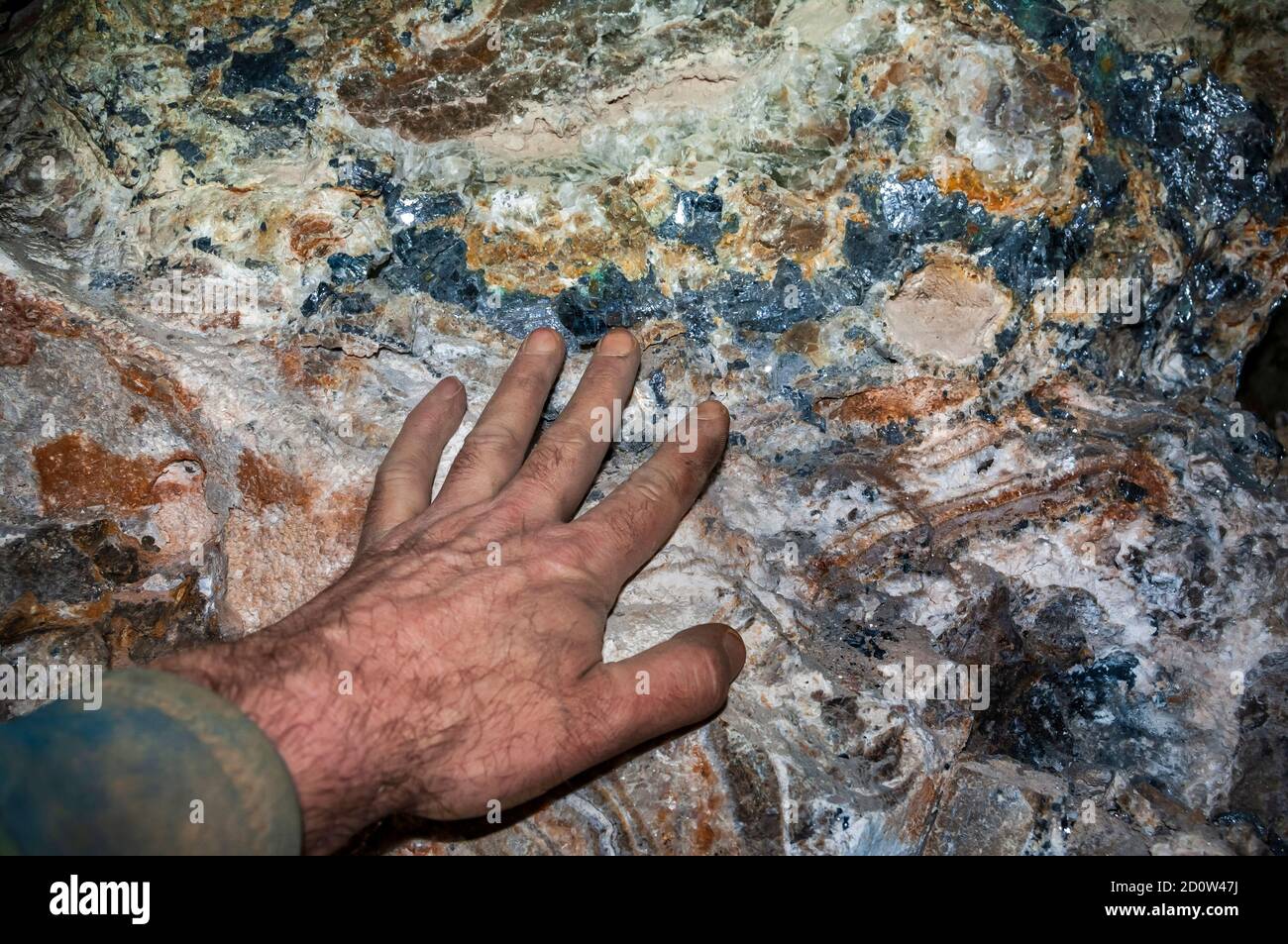 Vein of galena (lead ore) in a complex matrix of other minerals in a ...