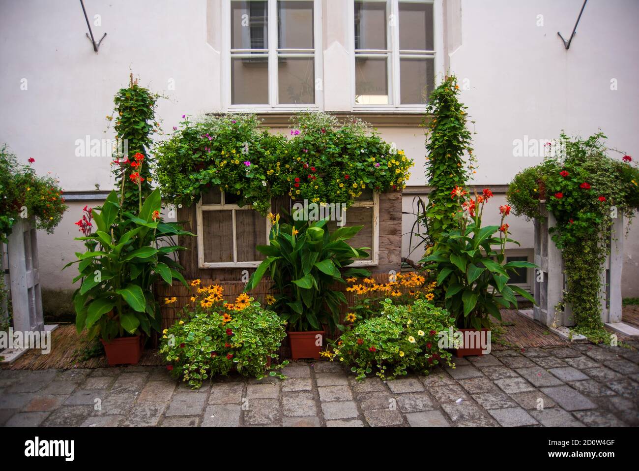 View of a house front decorated with flowers Stock Photo - Alamy
