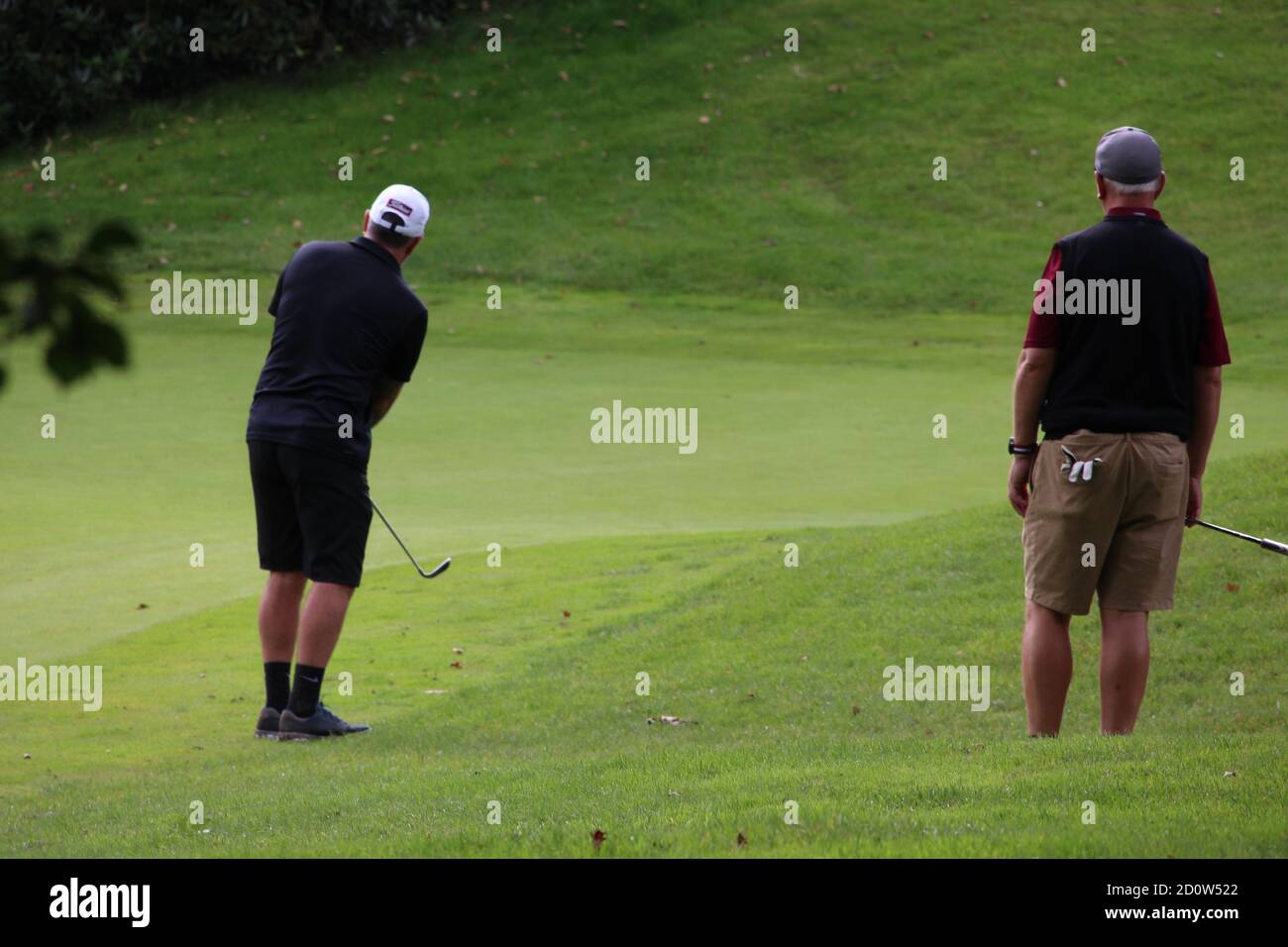A photograph of two white male golfers on a golf course Stock Photo - Alamy