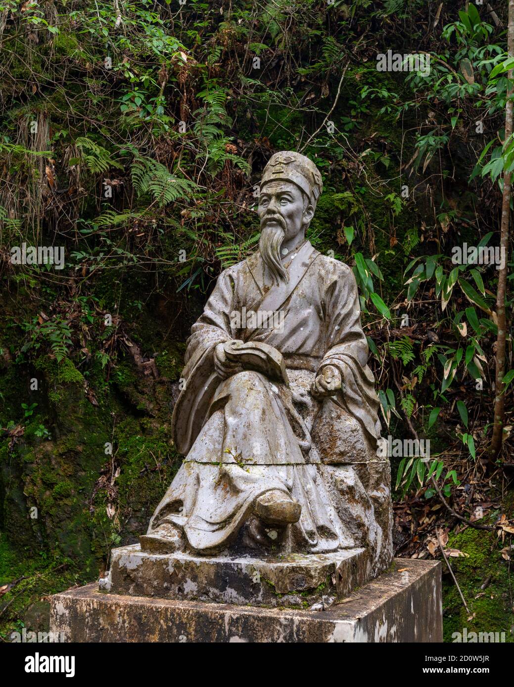 Chinese scholar statue in the jungle Stock Photo - Alamy