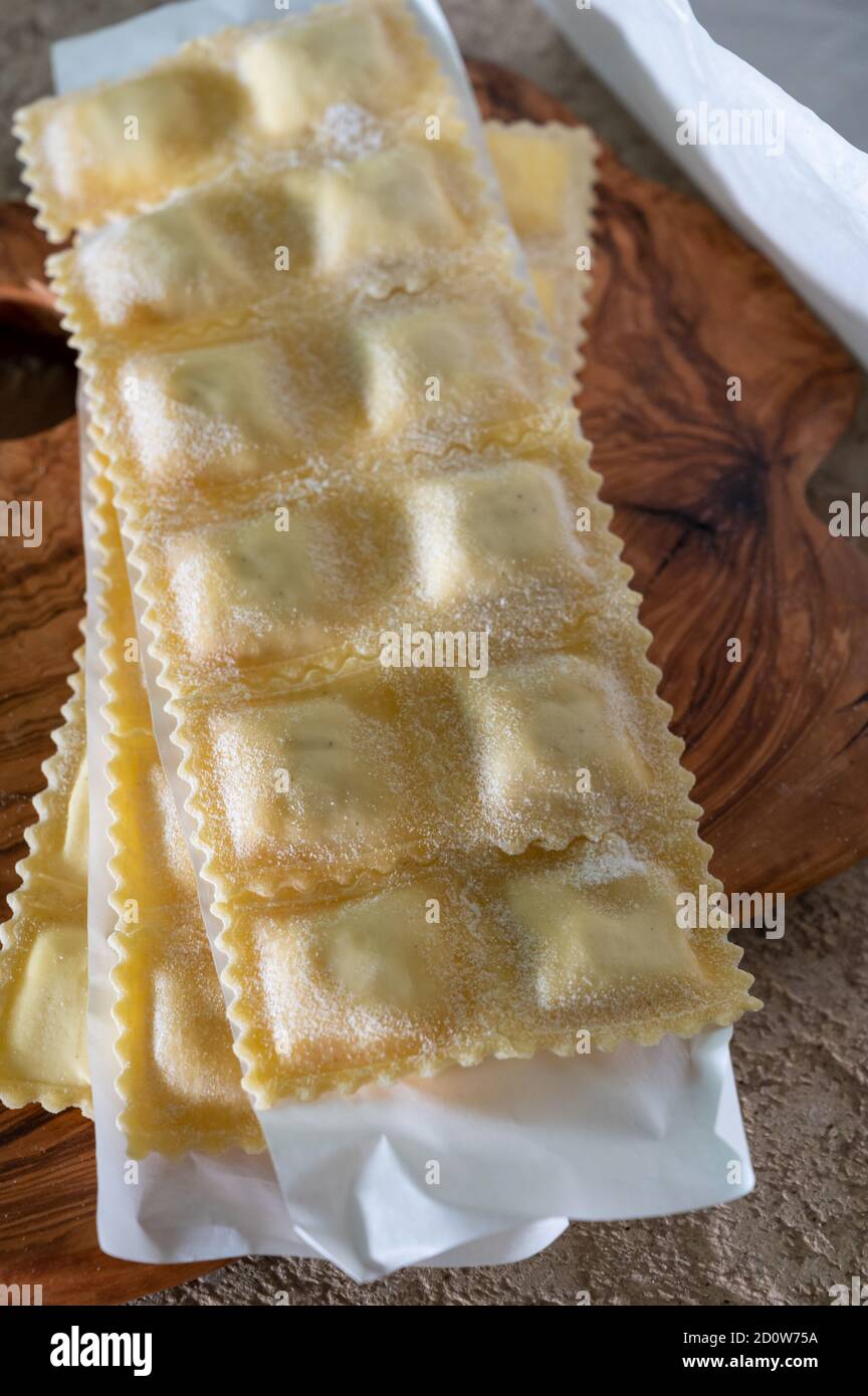 Handmade uncooked fresh ravioli with four cheeses filling, tasty ...