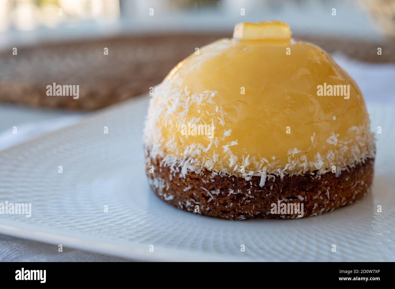 Small yellow lemon ball tart from French pastry shop close up Stock ...