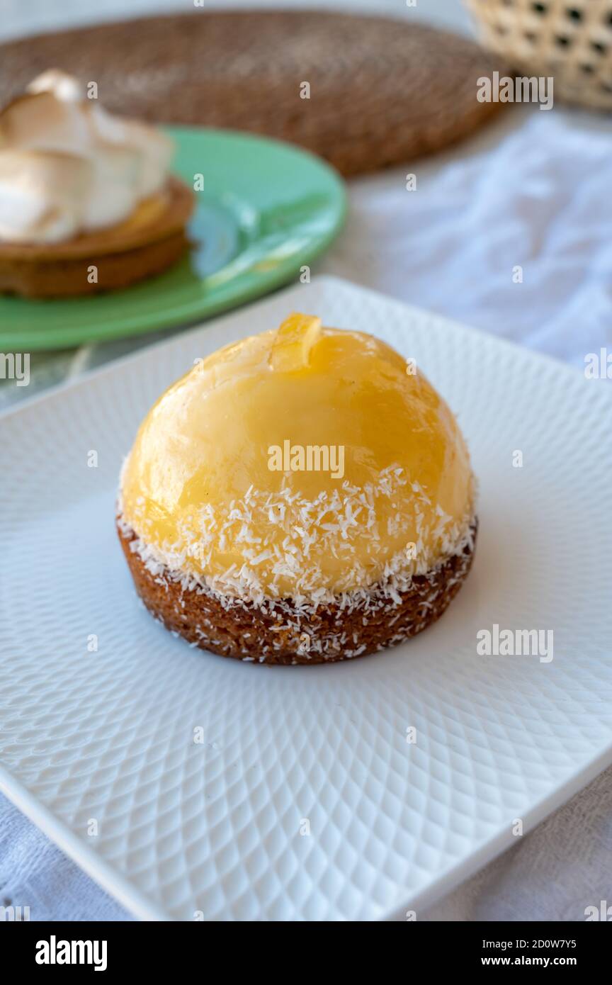Small yellow lemon ball tart from French pastry shop close up Stock ...