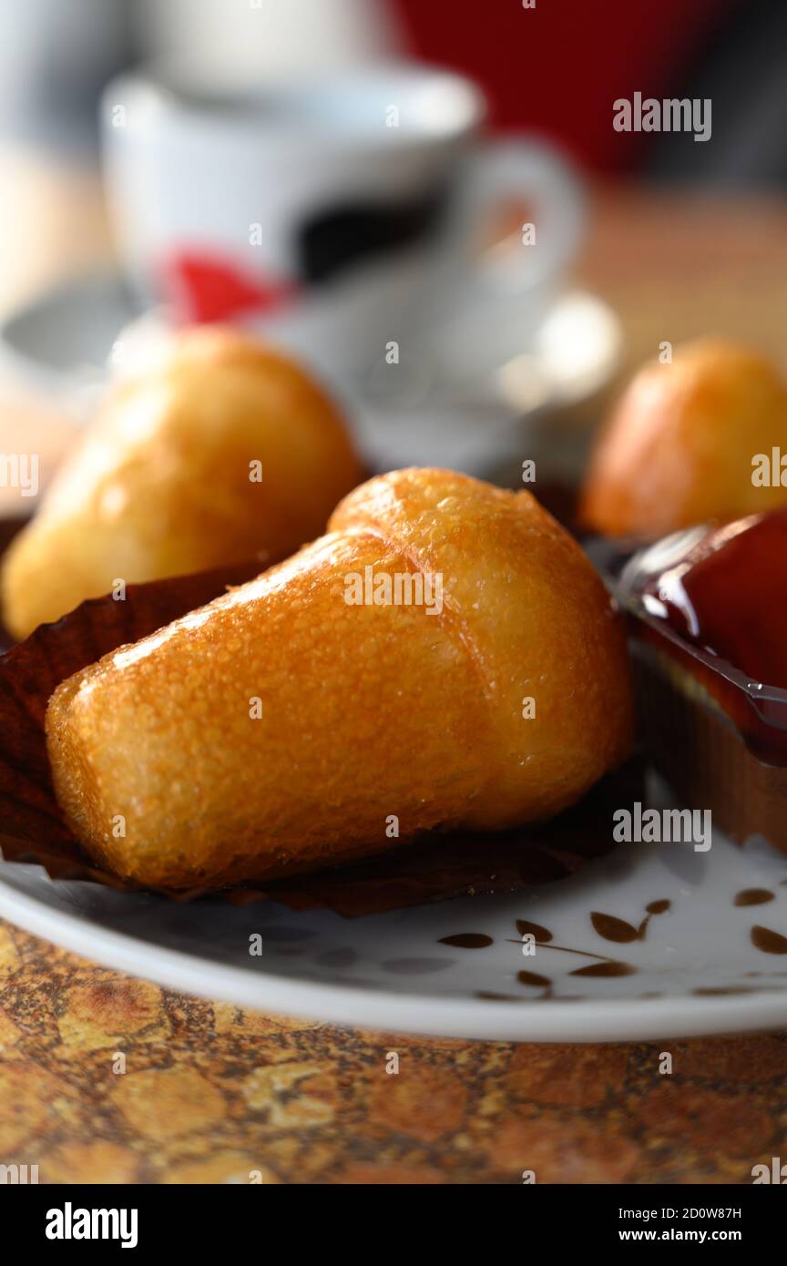Classic italian espresso coffee served with homemade rum baba soft cake ...