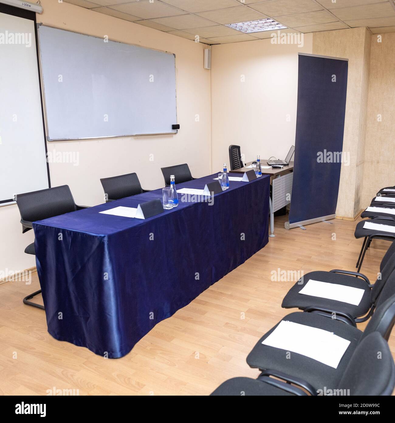Small empty event hall with chairs wide view Stock Photo - Alamy