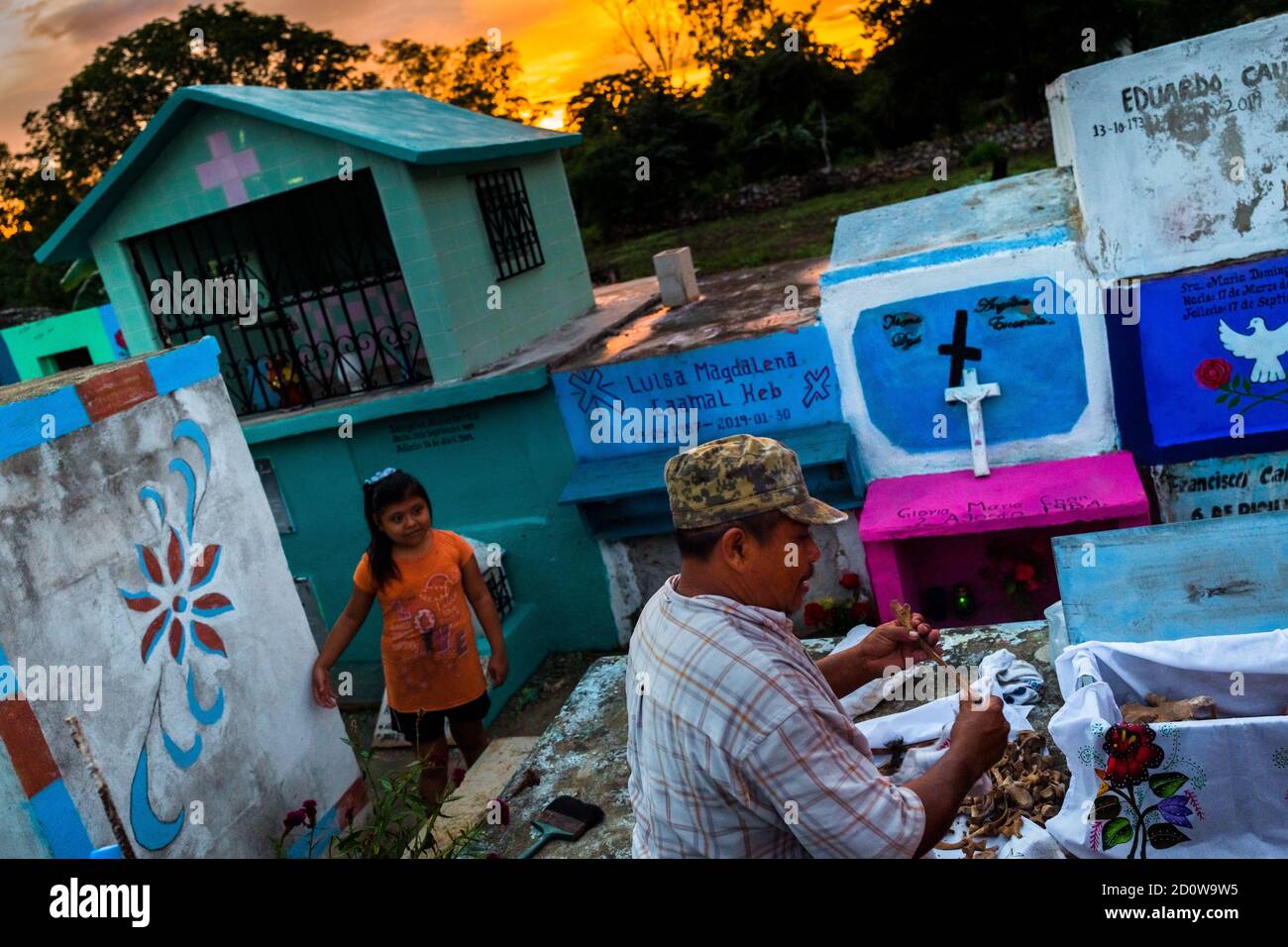 A Mayan peasant cleans dried-up bones of a deceased family member ...