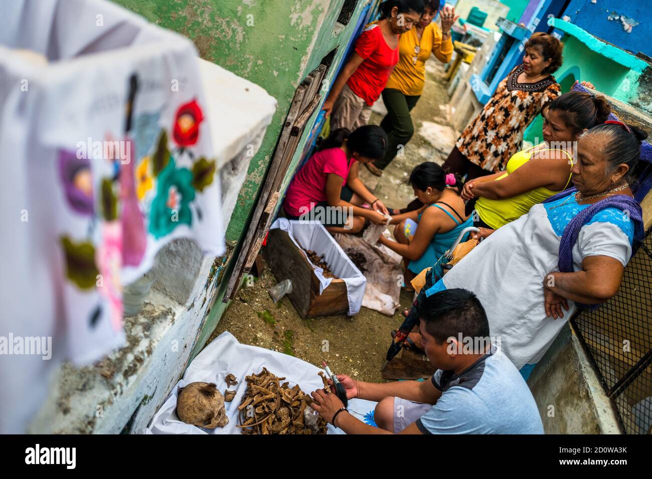 Mayan peasants clean dried-up bones of deceased family members during ...