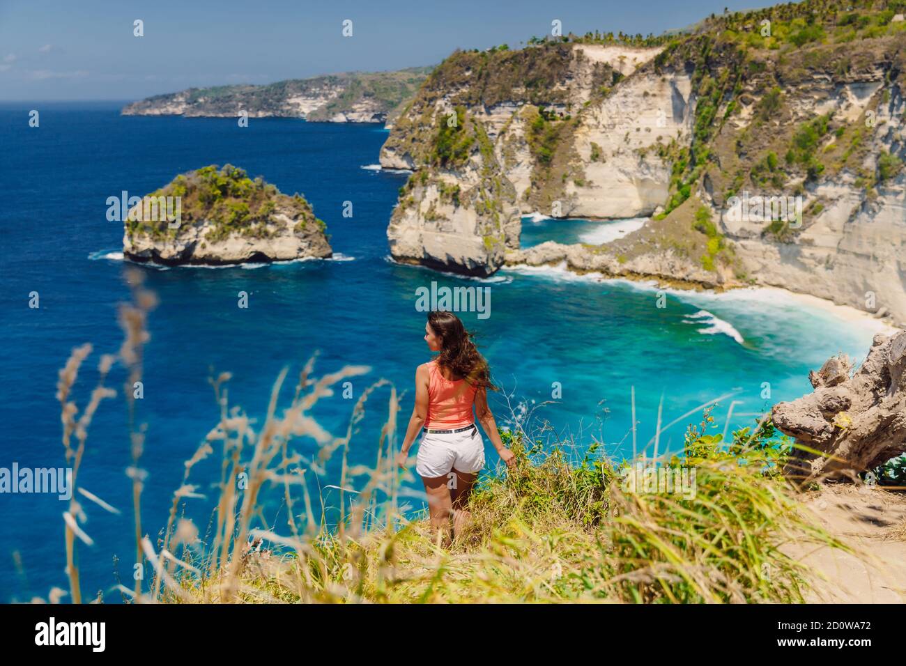 Traveller woman posing near Atuh beach and looks to ocean on Nusa ...