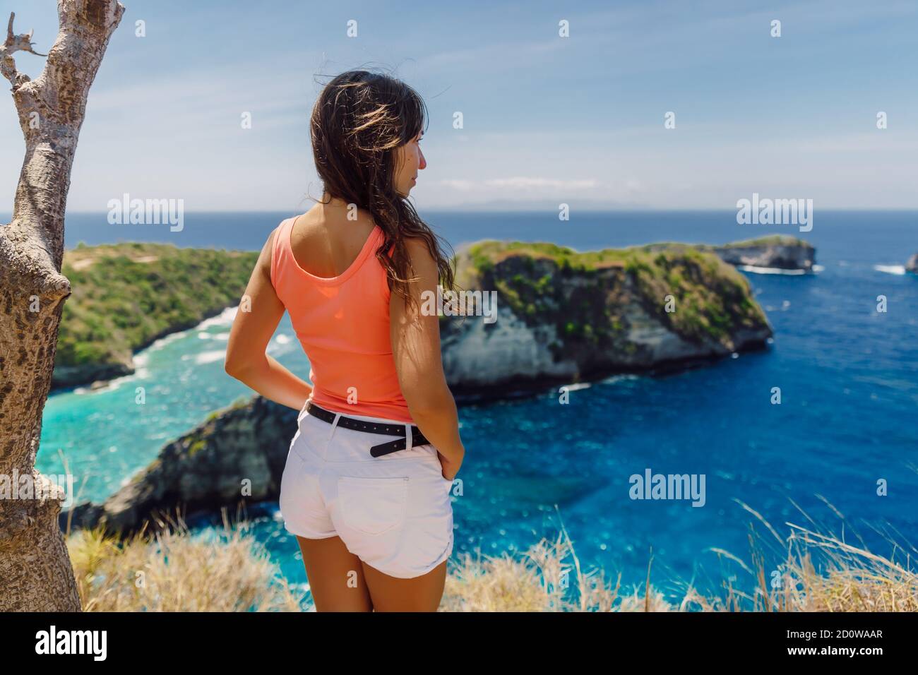 Traveller woman posing near Atuh beach and looks to ocean on Nusa ...