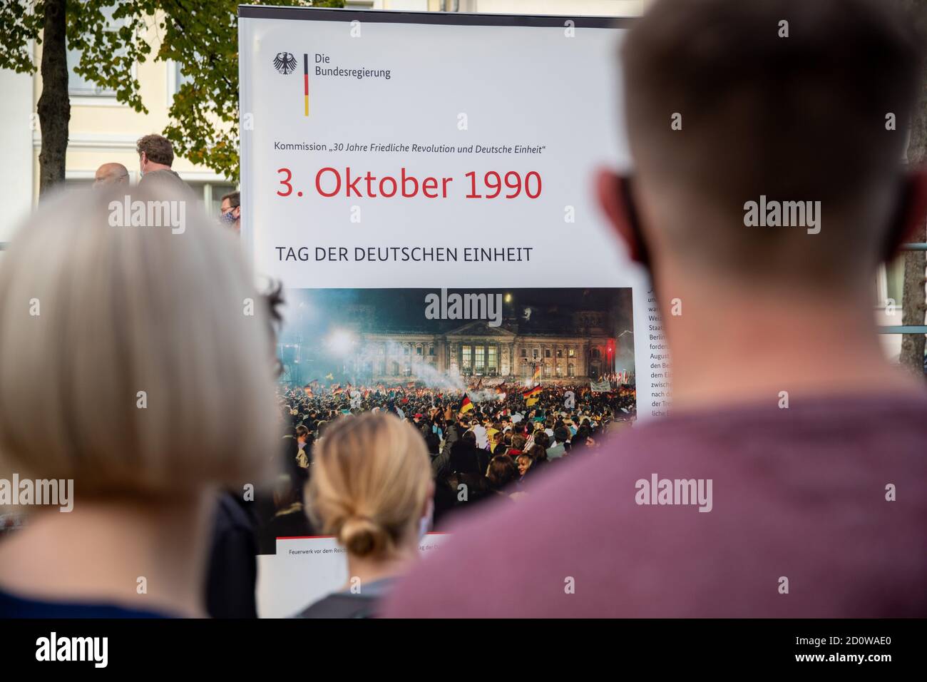 Potsdam, Germany. 03rd Oct, 2020. Visitors look at a plaque ...