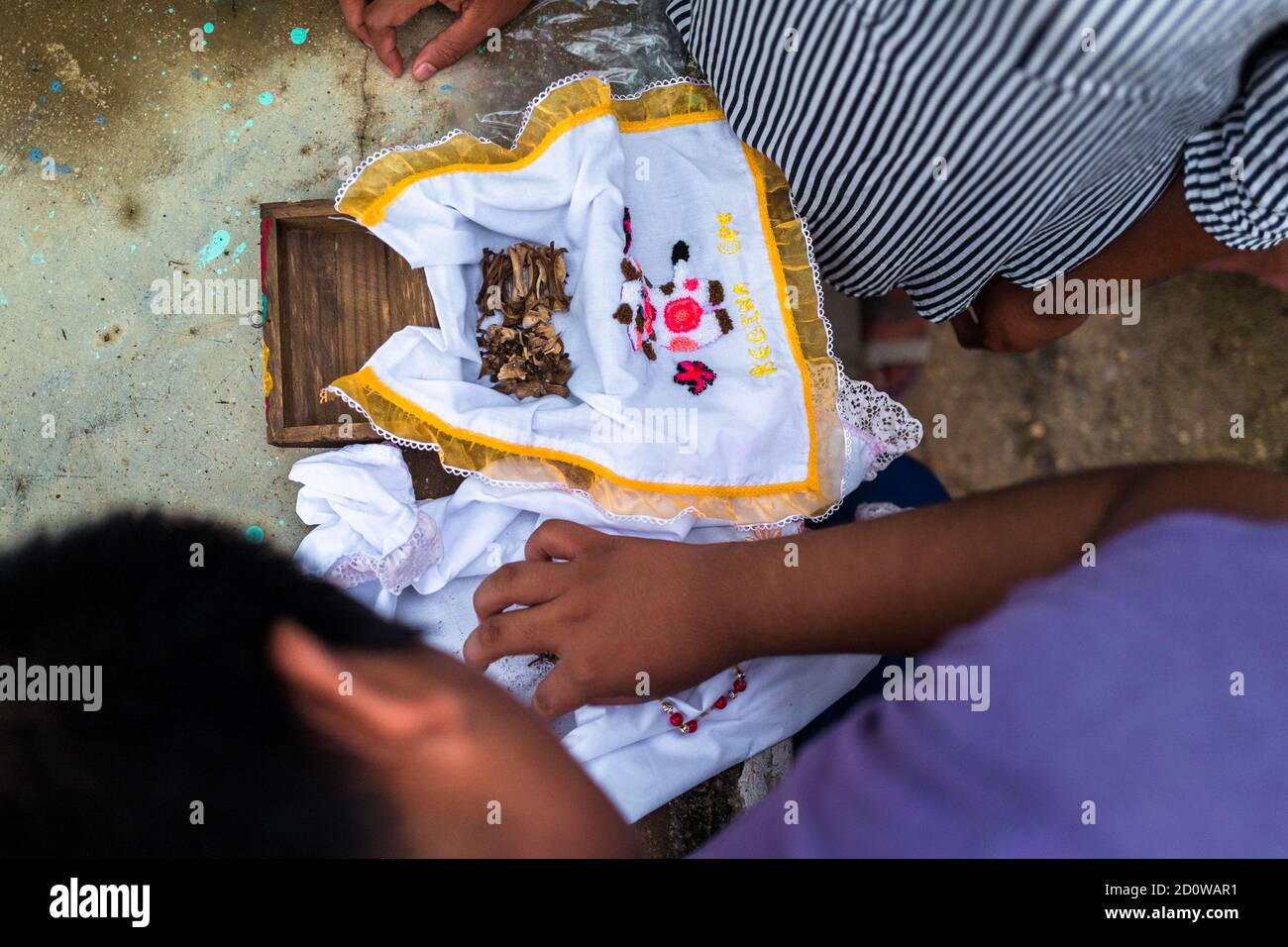 A Mayan man cleans dried-up bones of a un unborn baby from his family ...