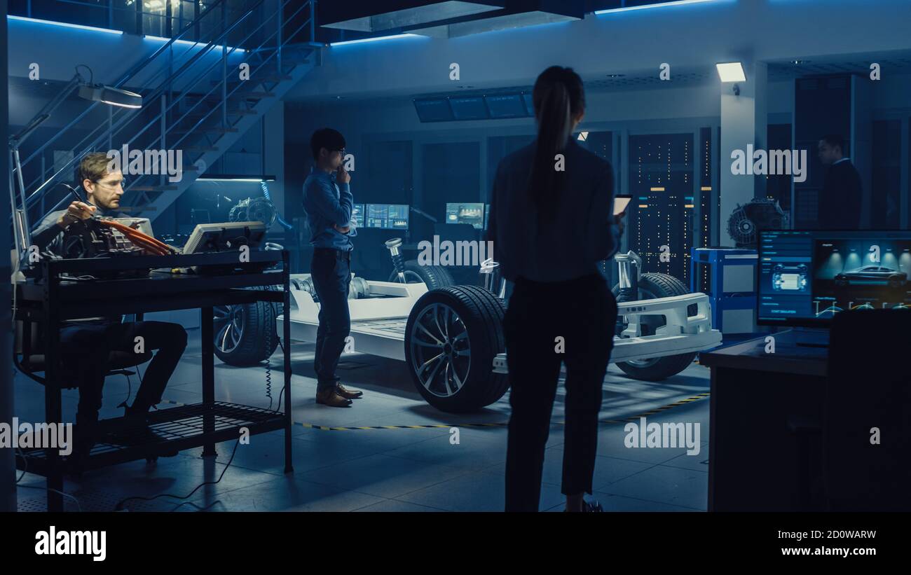 Automotive Design Engineers Talking while Working on Electric Car ...