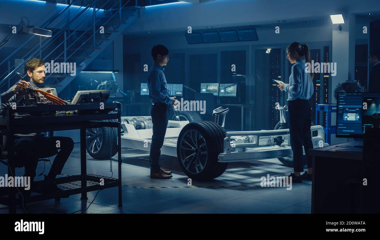 Automotive Design Engineers Talking while Working on Electric Car ...